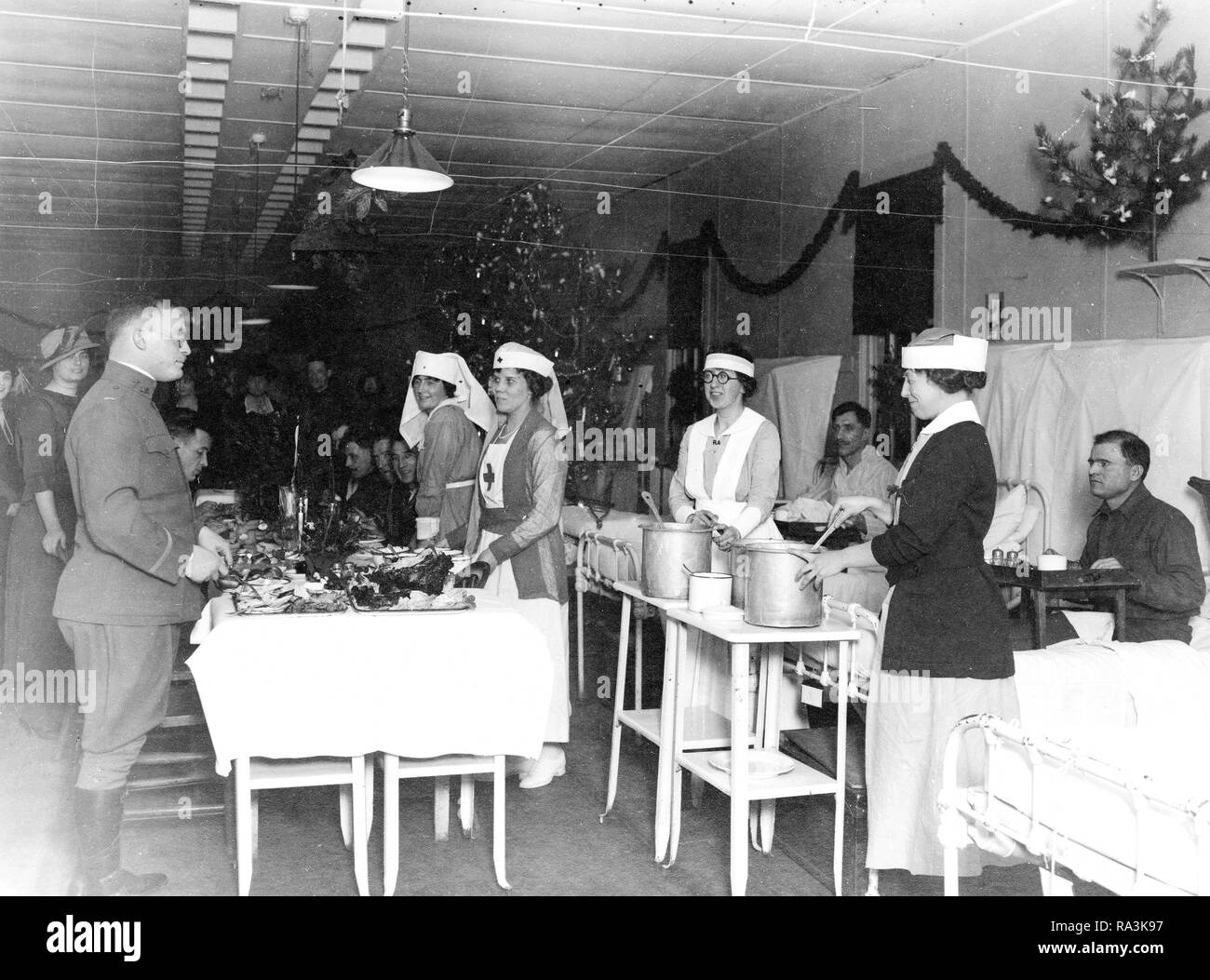 Red Cross nurses serving food to soldiers in hospital, during Christmas ...