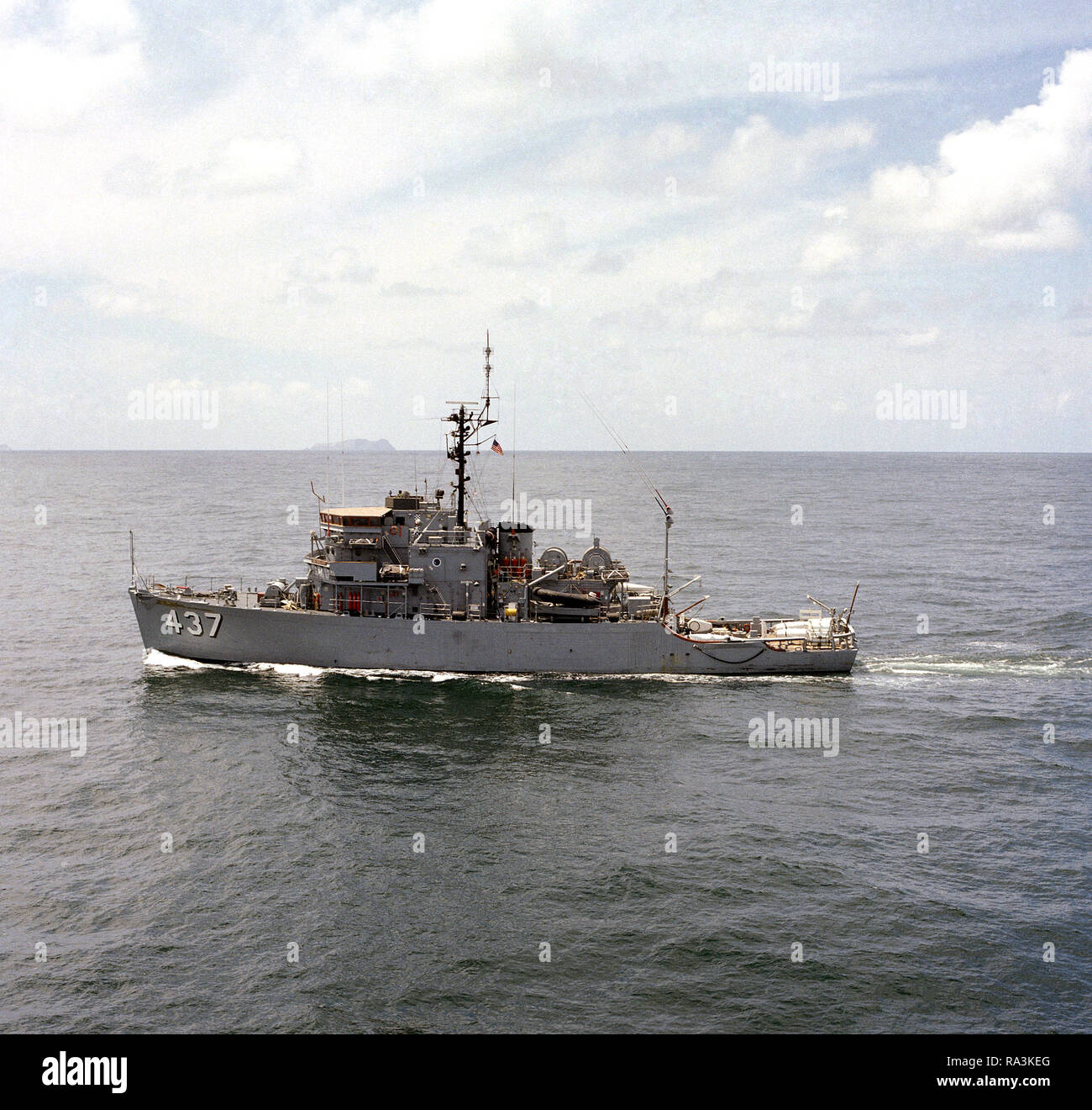 1977 - An elevated port beam view of the ocean minesweeper USS ENHANCE ...