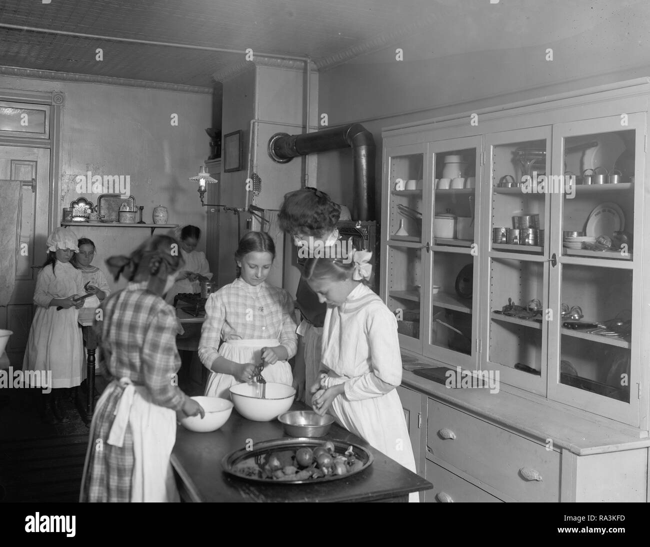 Women and girls working in a kitchen ca. early 1900s Stock Photo - Alamy