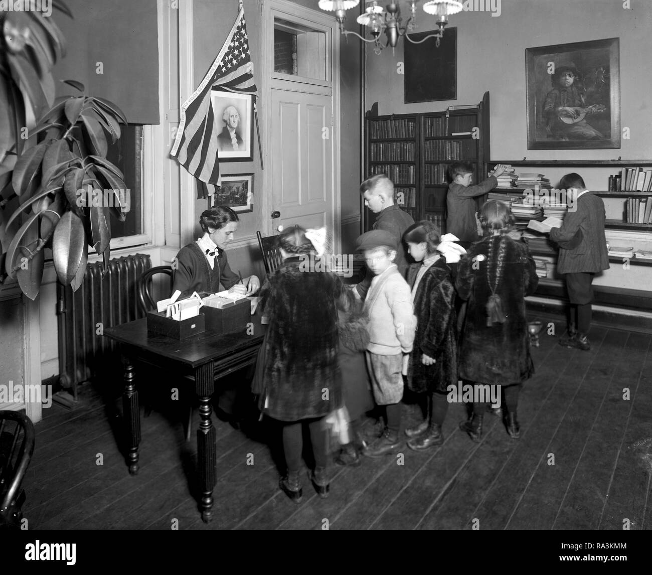Children and librarian in an early 1900s library Stock Photo - Alamy