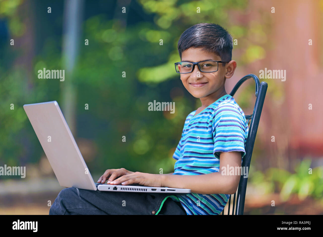 Child working on laptop Stock Photo - Alamy