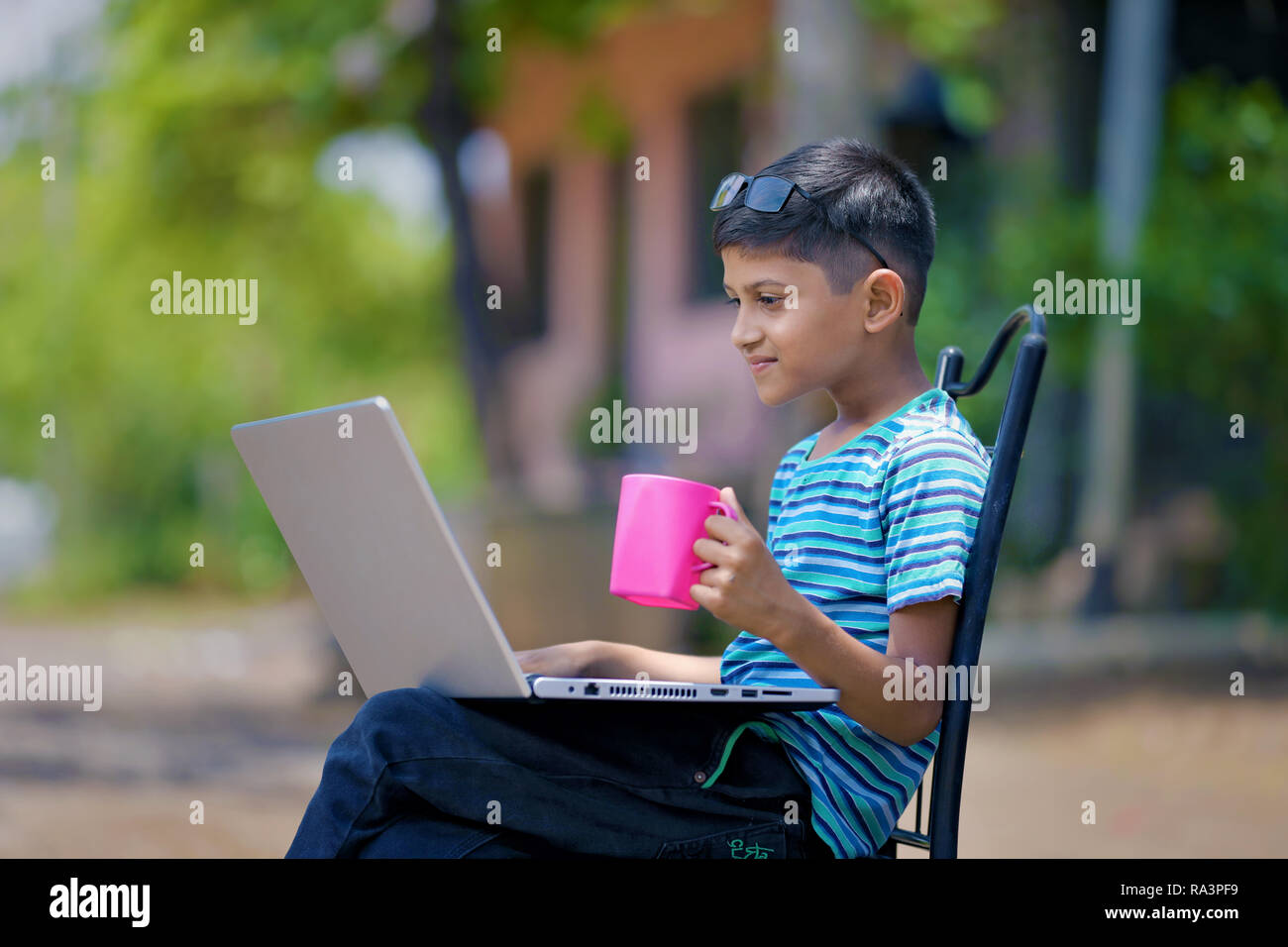 Child working on laptop Stock Photo - Alamy
