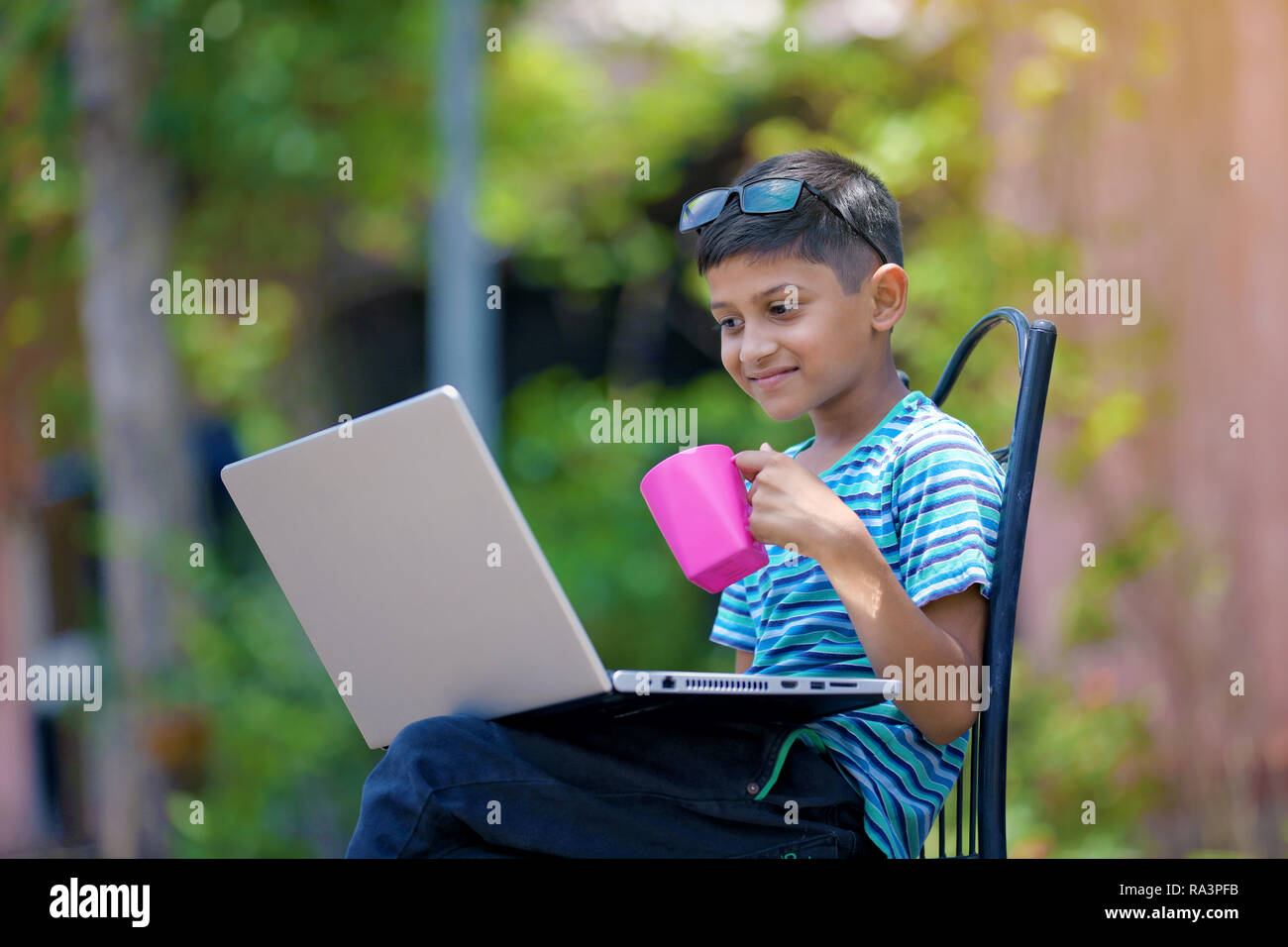 Child working on laptop Stock Photo - Alamy