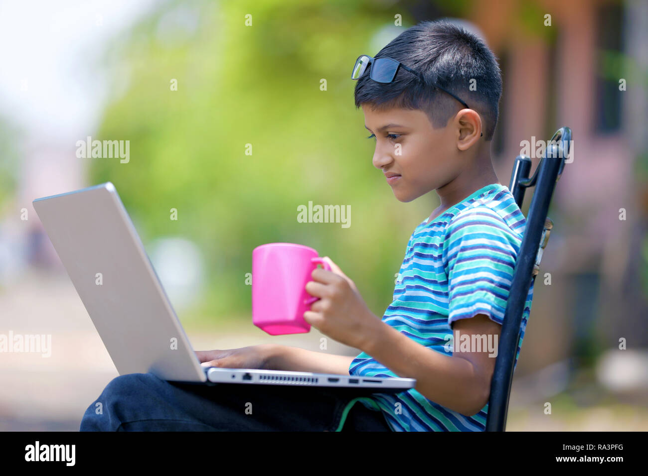 Child working on laptop Stock Photo - Alamy