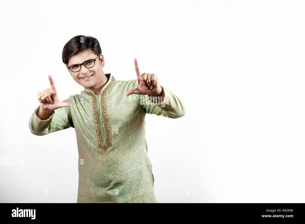 young indian man on traditional wear making frame with hand Stock Photo ...