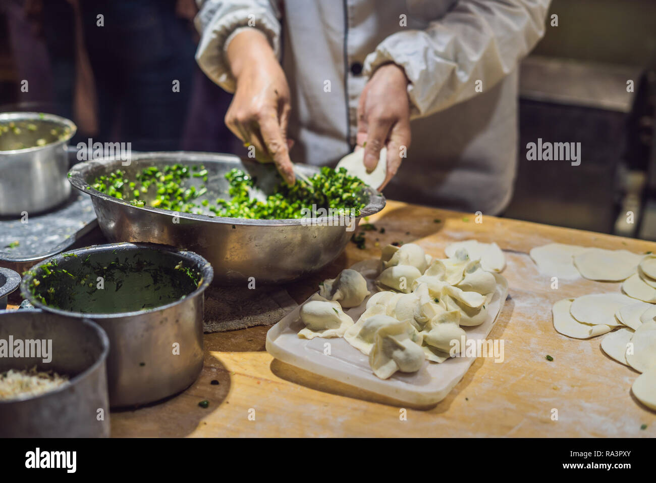 Chinese chef making dumplings in the kitchen Stock Photo - Alamy