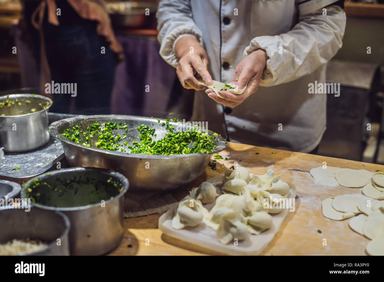 Chinese chef making dumplings in the kitchen Stock Photo - Alamy