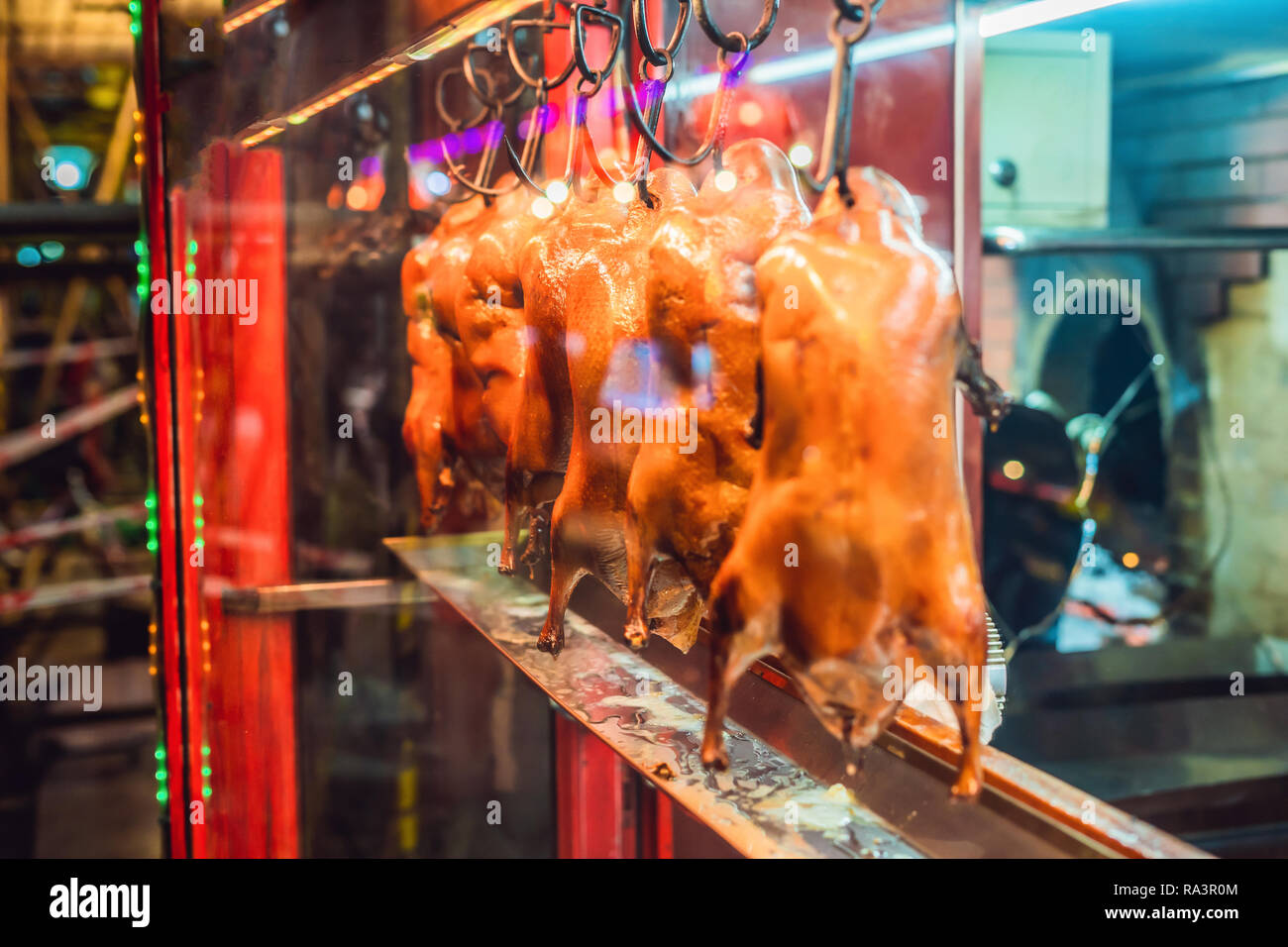 Peking duck is roasting in the oven, preparing to serve on the cost ...