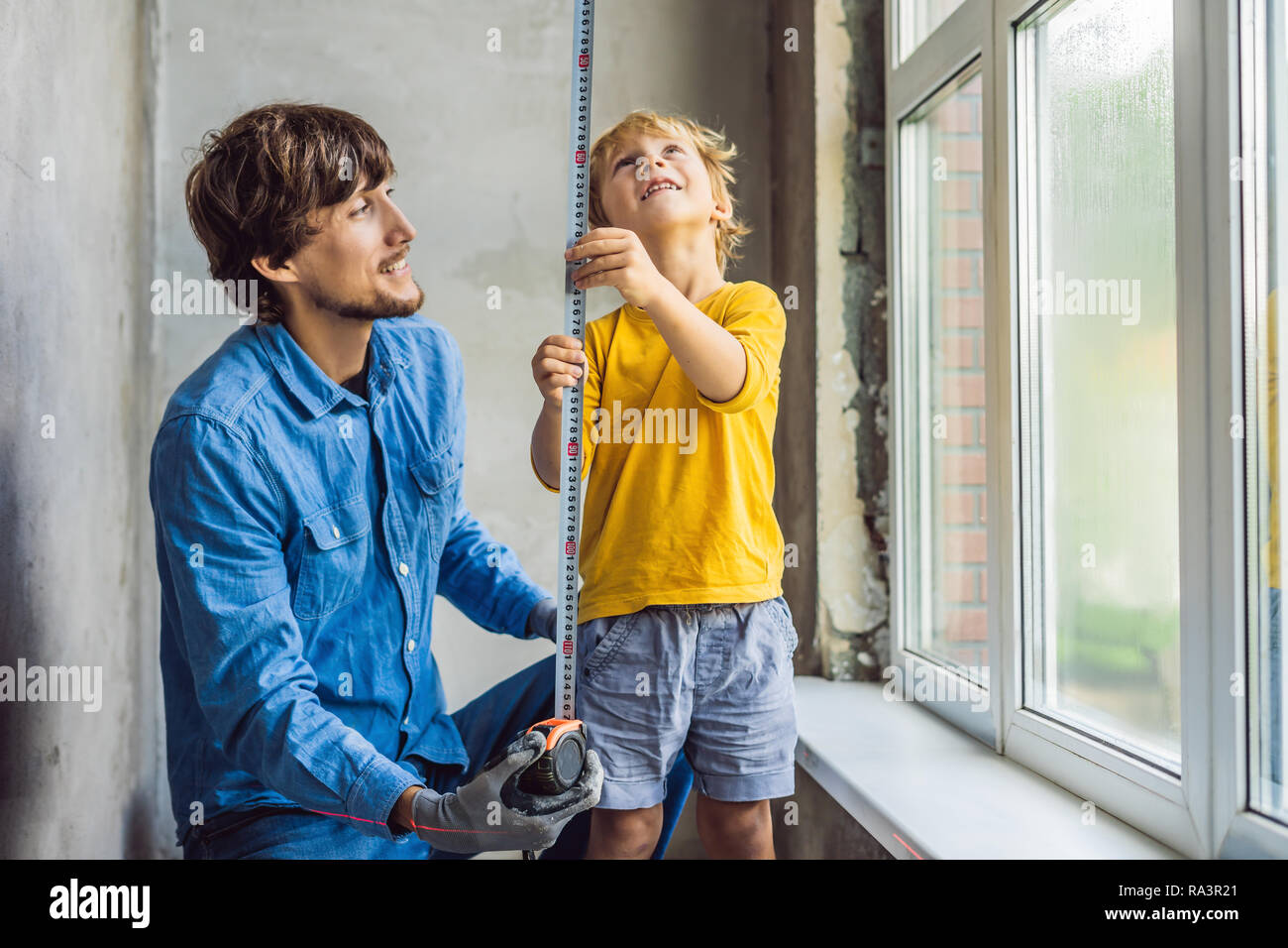 Father and son repair windows together. Repair the house yourself Stock ...