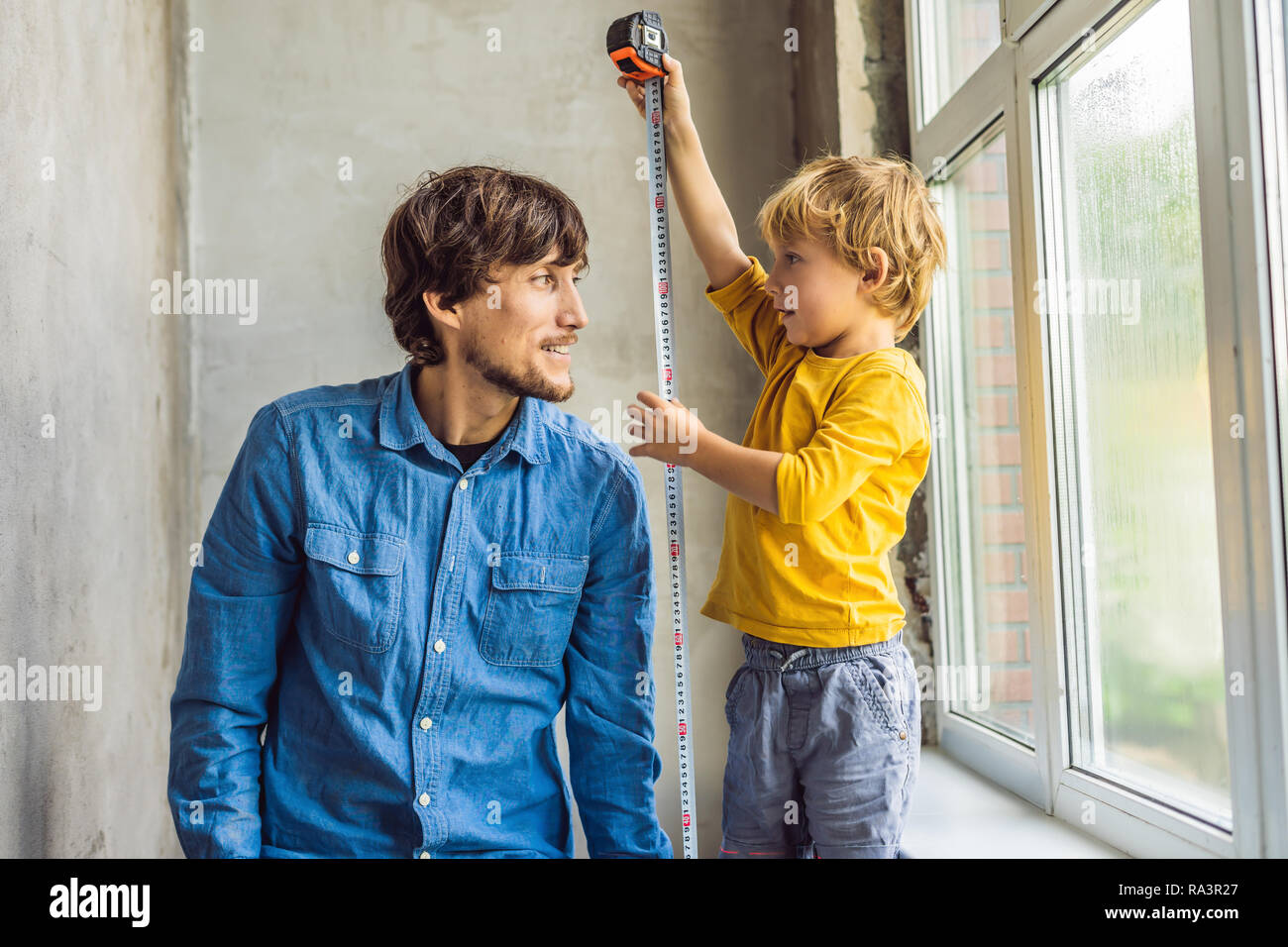 Father and son repair windows together. Repair the house yourself Stock ...
