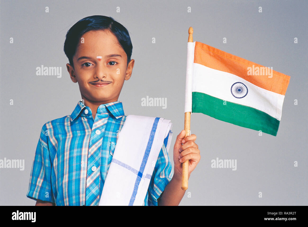 South Indian Boy dressed in traditional costume, wearing a false ...