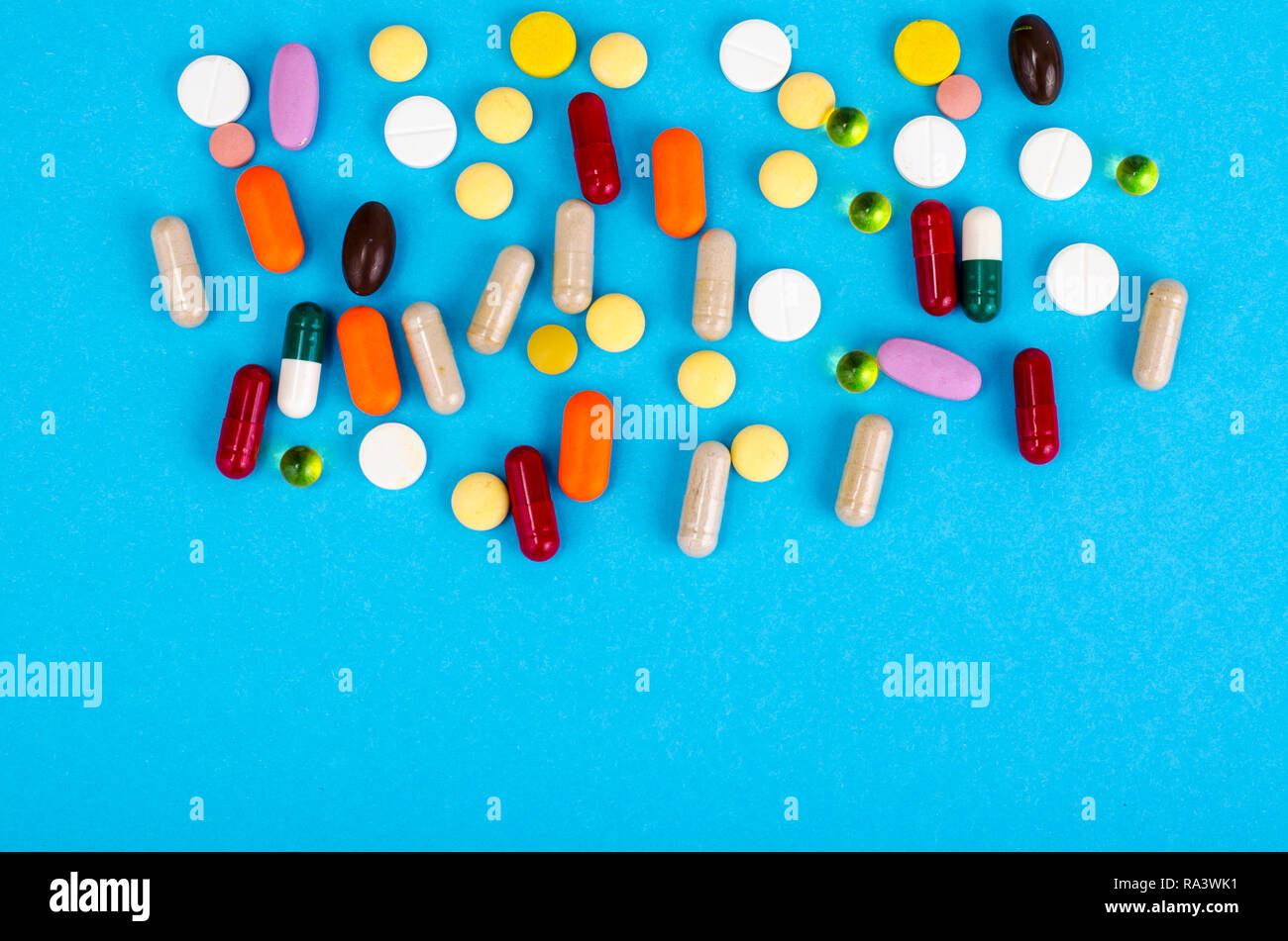 Assorted pharmaceutical medicine pills, tablets and capsules on bright ...