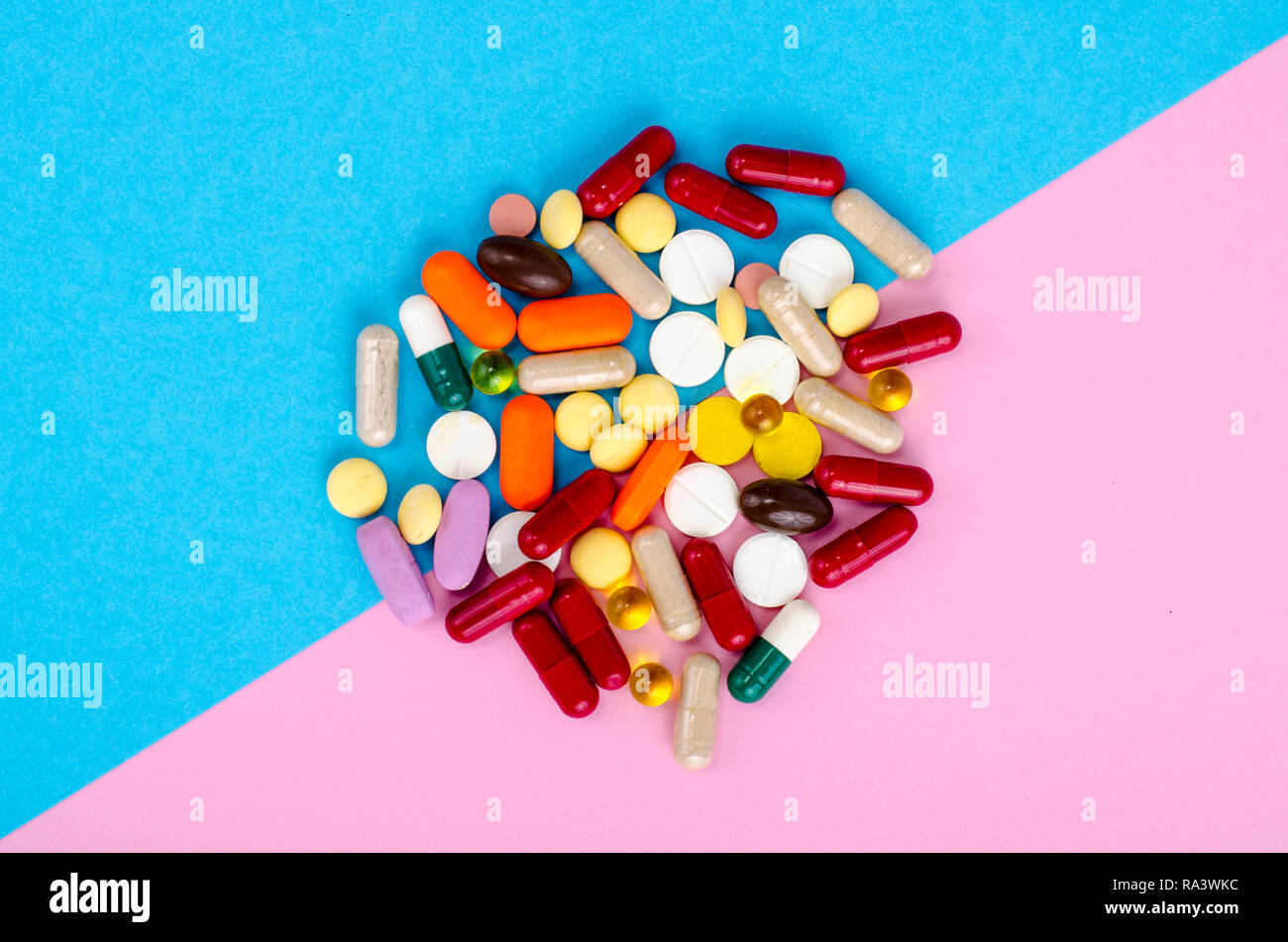 Assorted pharmaceutical medicine pills, tablets and capsules on bright ...