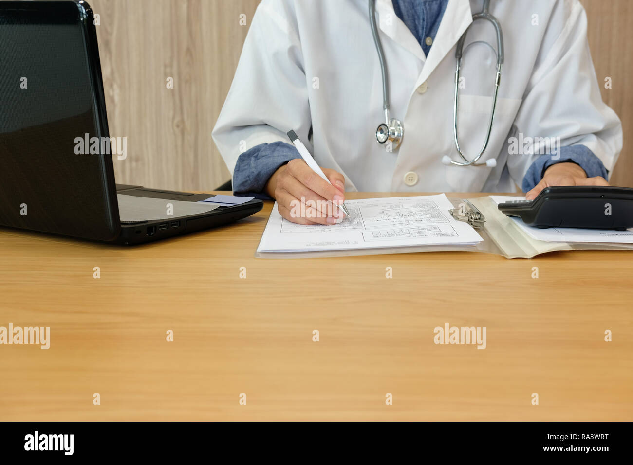 doctor physician with stethoscope calculate medical fee costs & revenue ...