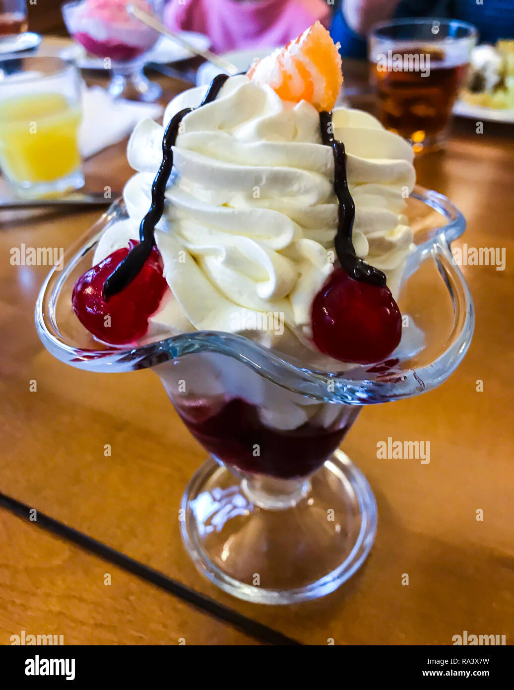 Dessert with whipped cream, berries and chocolate topping. Studio Photo ...