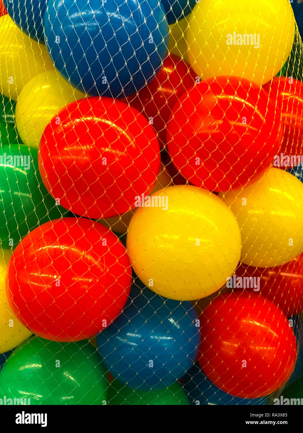 Plastic colored balls in grid. Studio Photo Stock Photo - Alamy