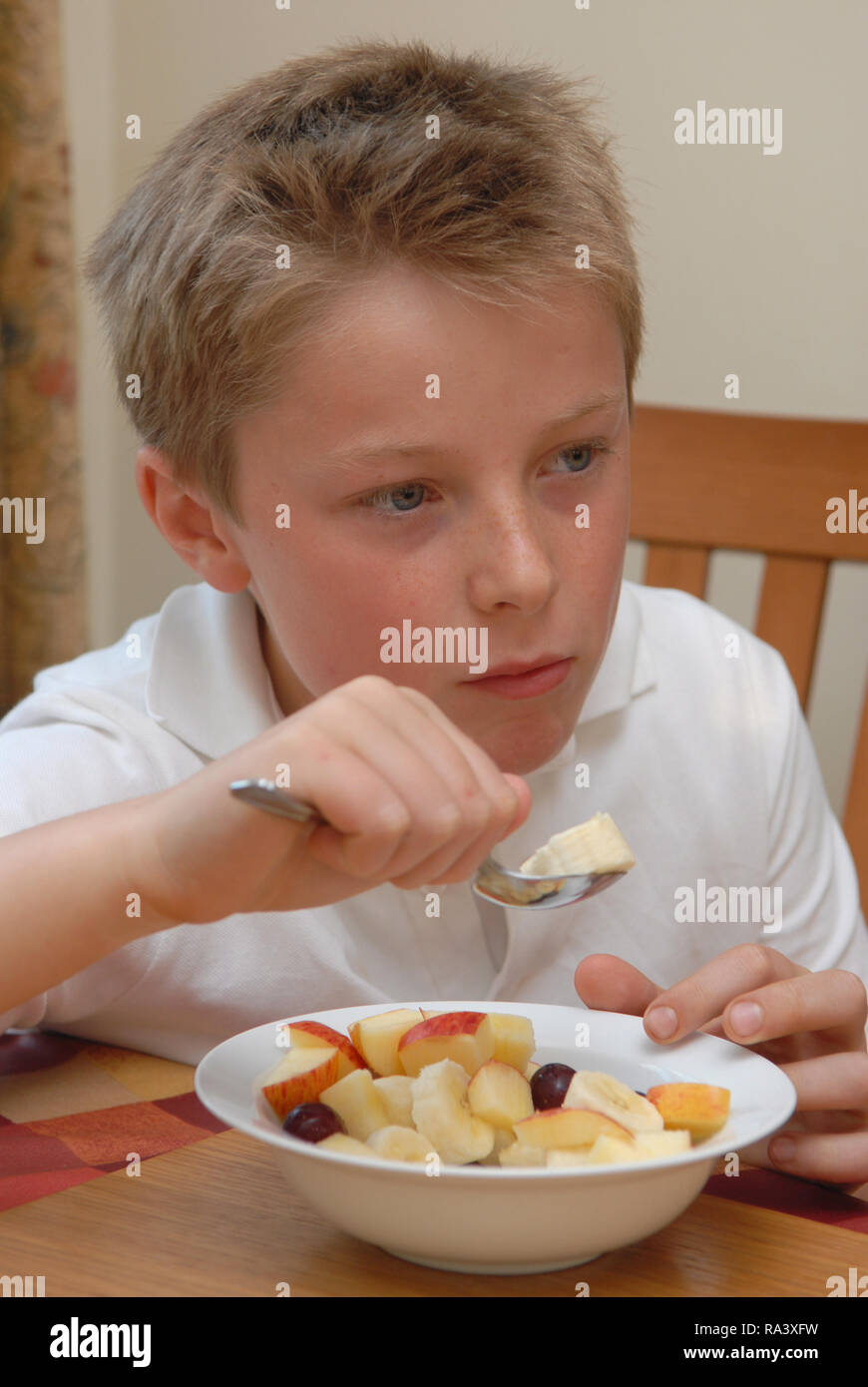 A young boy eating a fruit salad Stock Photo - Alamy