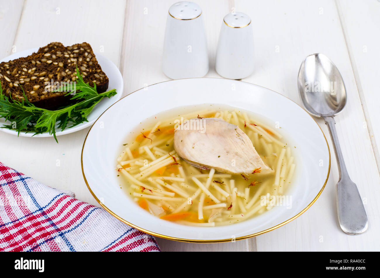 Chicken broth noodle soup on white wooden background Stock Photo - Alamy