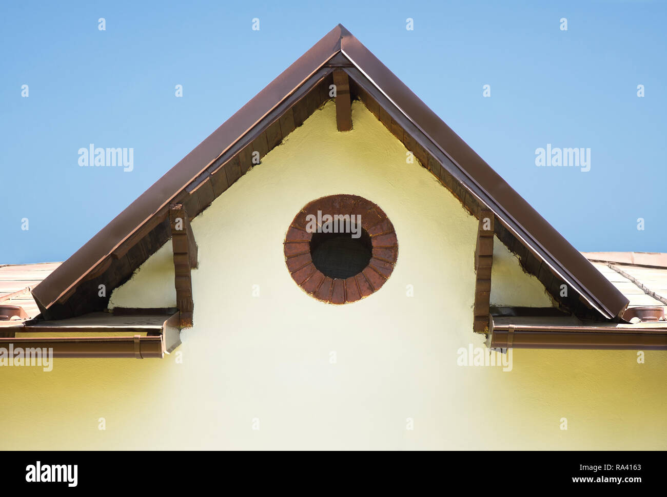 Detail of a rustic building with a round window Stock Photo - Alamy