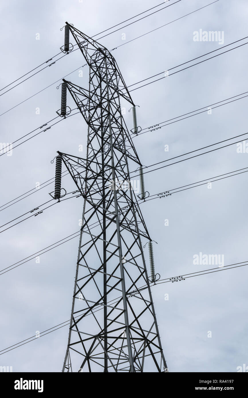 Electricity pylon and overhead power lines looking upwards towards the ...