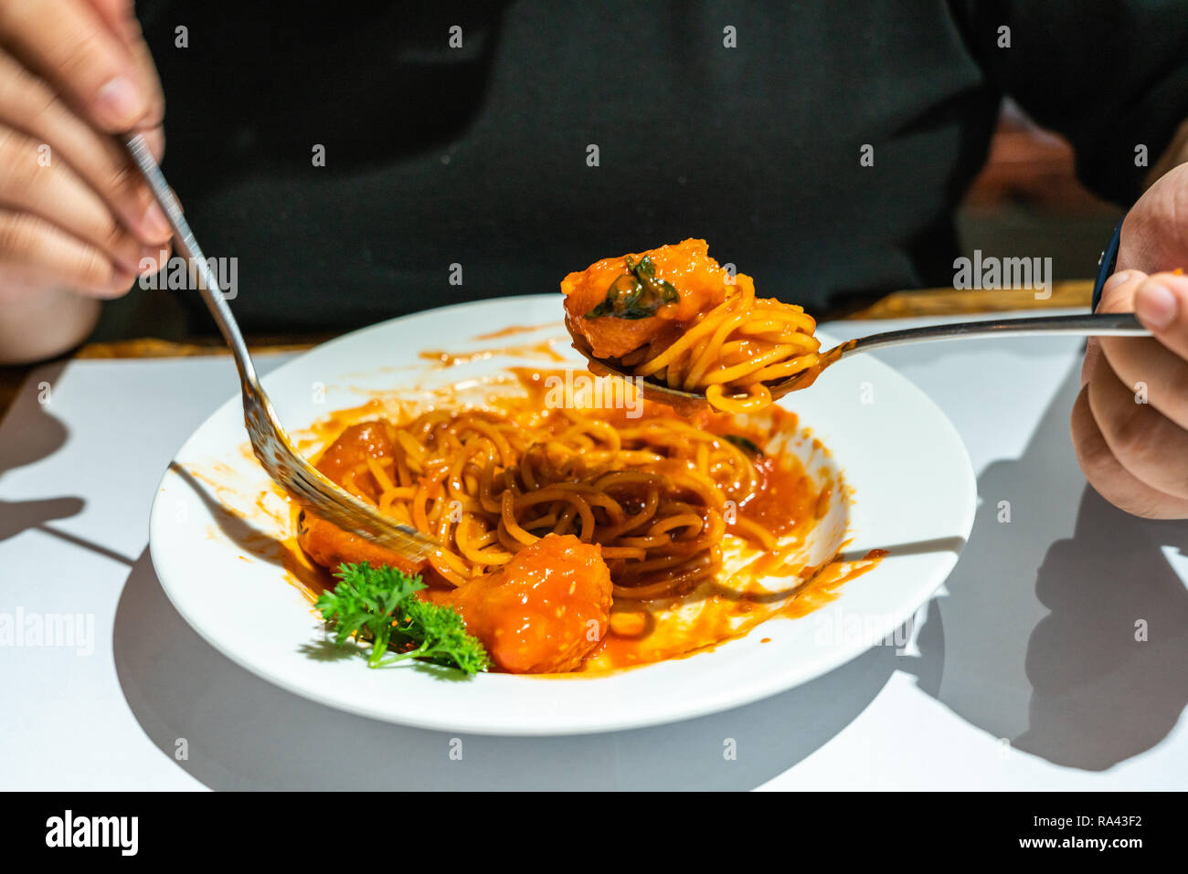Females hand eating Spaghetti Stock Photo - Alamy