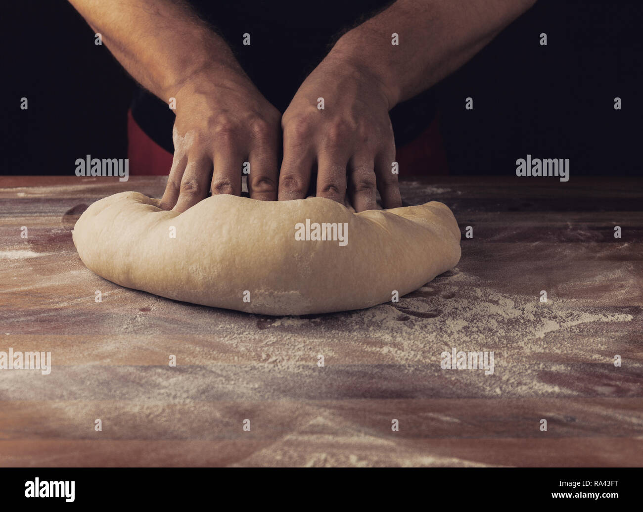 Chief baker preparing dough for bread in a bakery. Kitchen professional ...