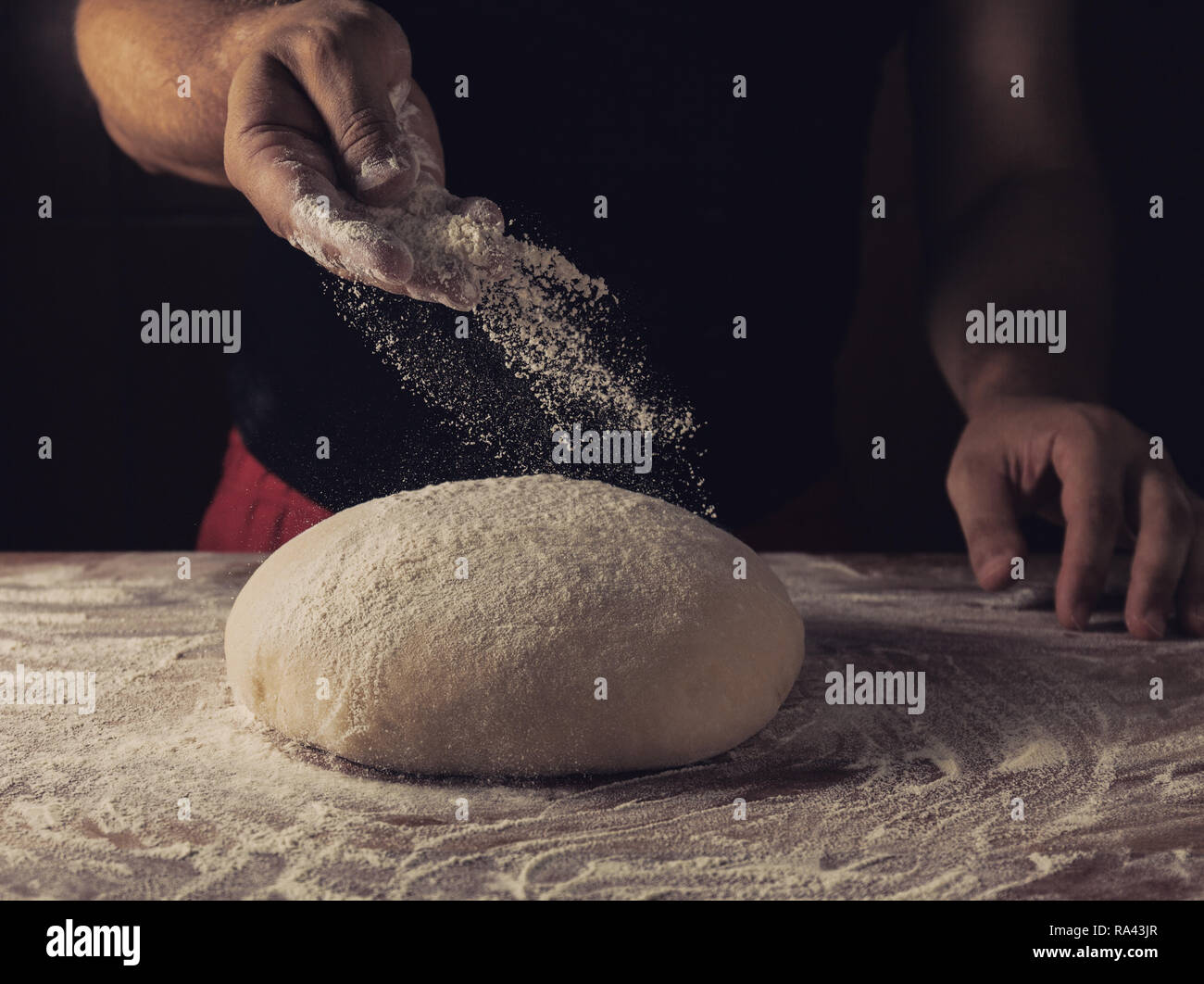 Chief baker preparing dough for bread in a bakery. Kitchen professional ...