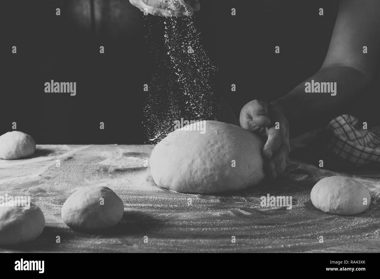 Chief baker preparing dough for bread in a bakery. Kitchen professional ...