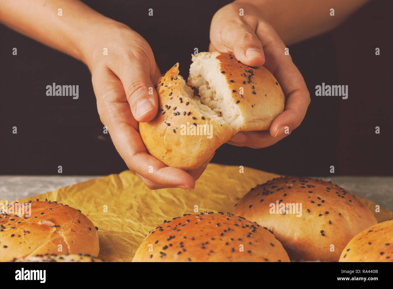 Breaking bread hands hi-res stock photography and images - Alamy