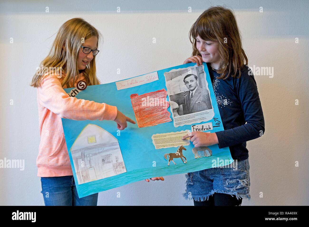 Two students with poster giving a presentation, primary school, Lower ...