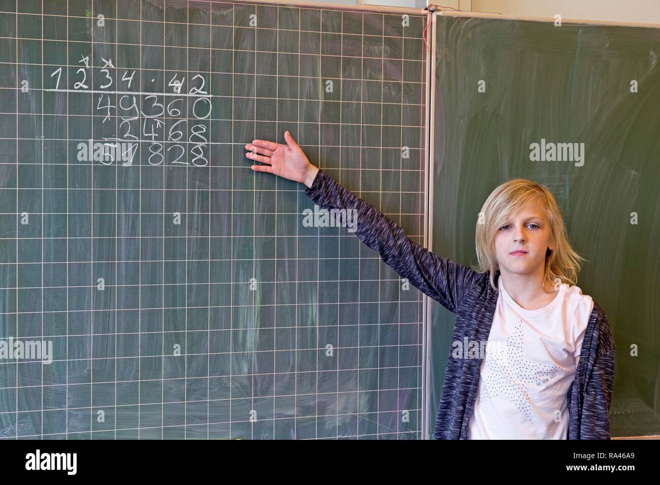 Student calculating on the blackboard, mathematics lessons, primary ...