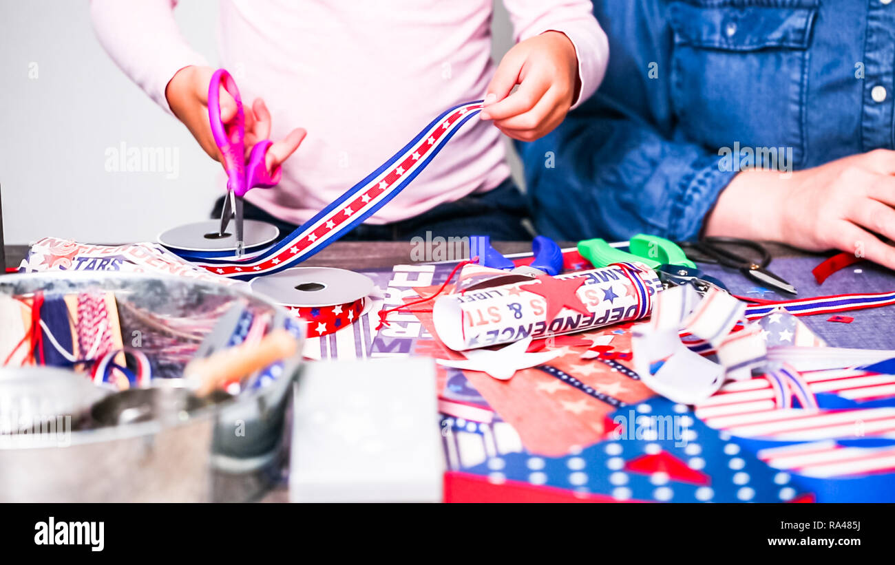 Step by step. Mother and daughter making paper firecrackers for July ...