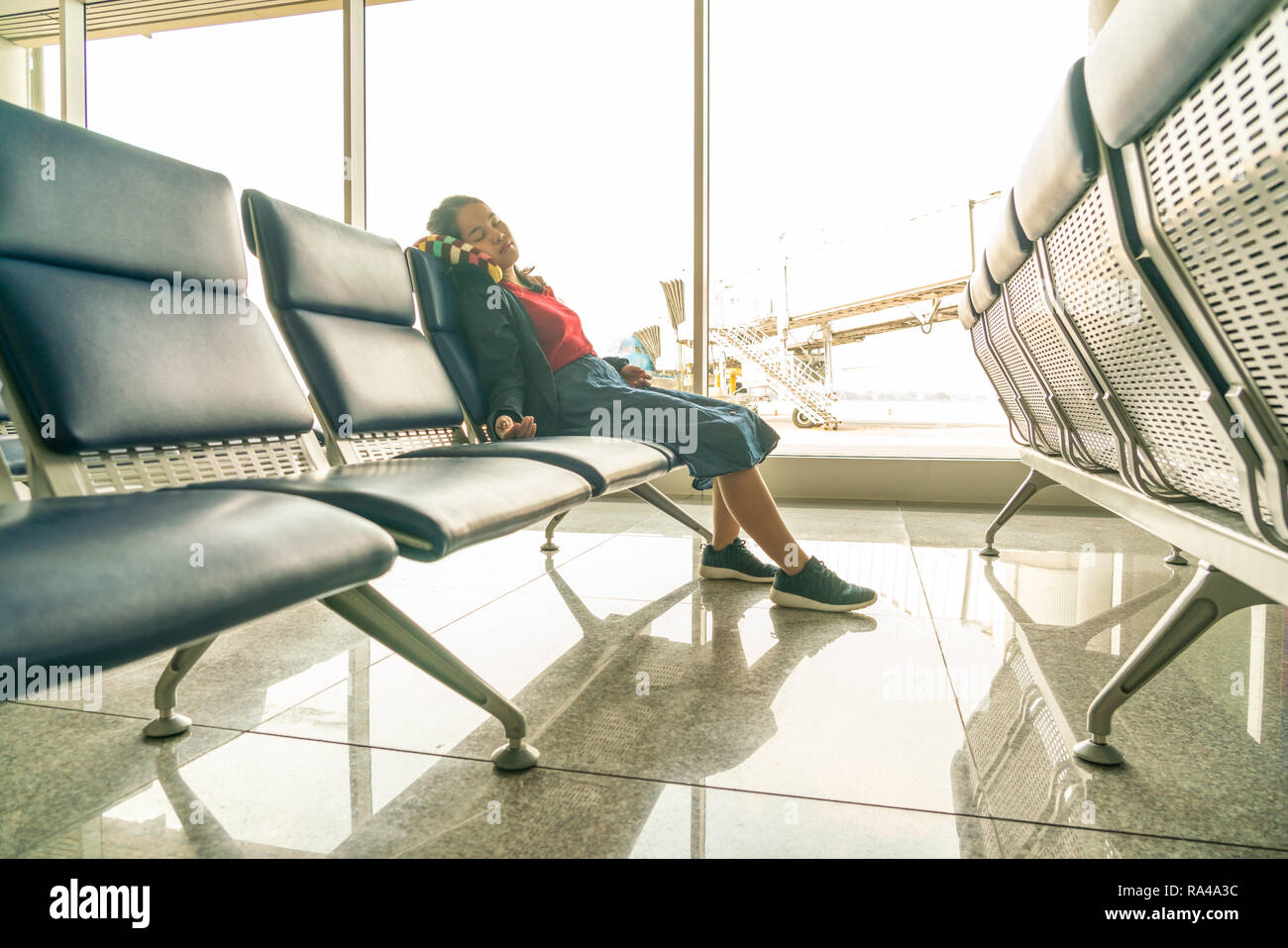 Tired woman waiting and sleeping at the airport Stock Photo - Alamy