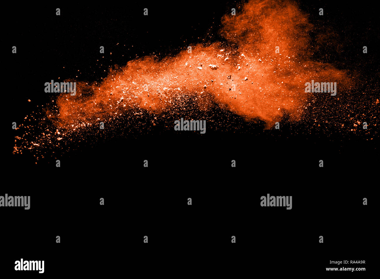 Orange powder dust particles explosion on black background Stock Photo ...