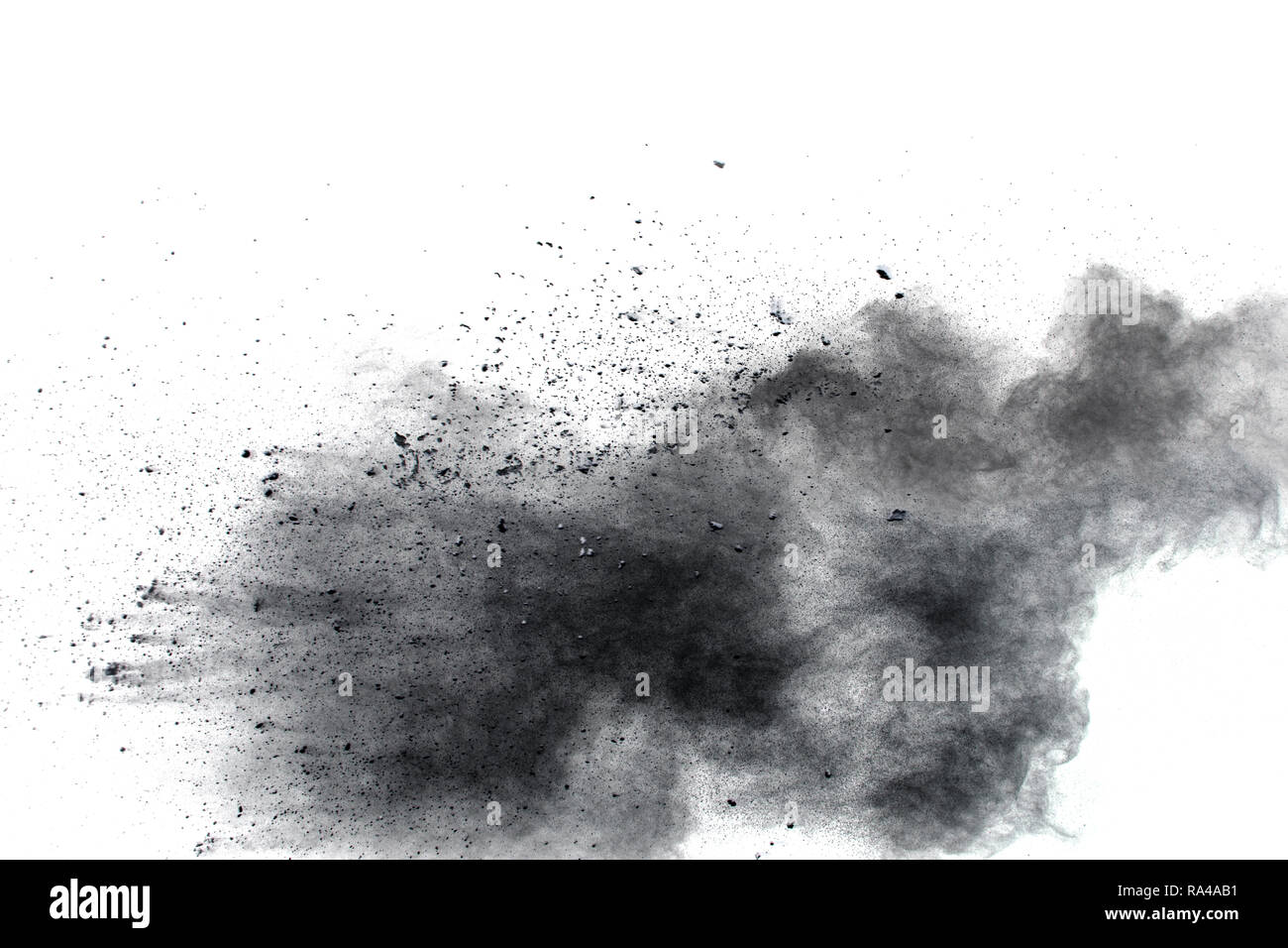 Black powder explosion. The particles of charcoal splatter on white ...