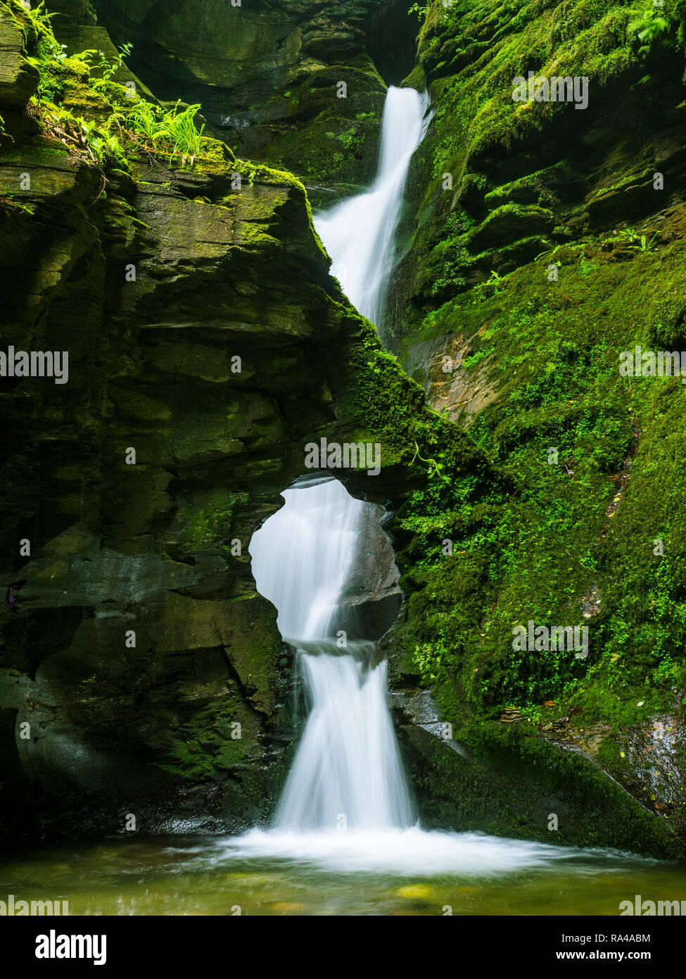 Water flows through a hole in the rock at St Nectan's waterfall Stock ...