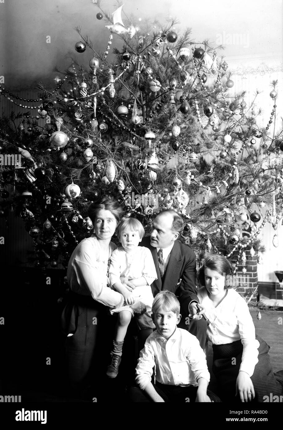 Family in front of their Christmas tree at home in early 1900s ca. 1921 ...