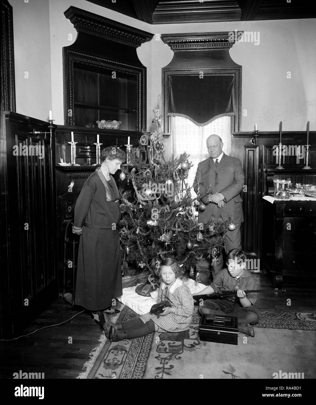 Parents with children around a Christmas tree ca. early 1900s (ca. 1921 ...