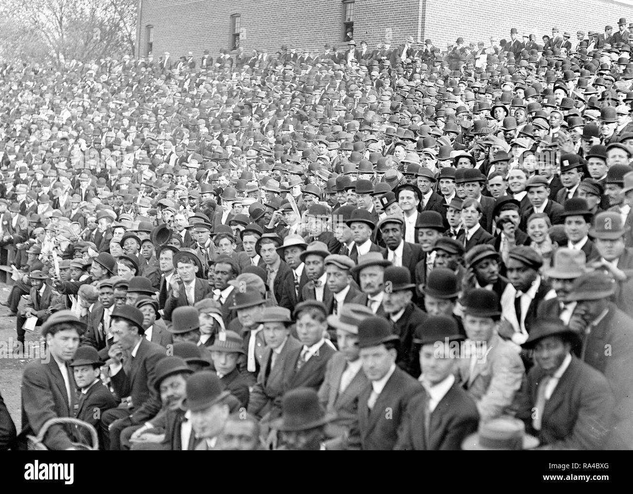 Crowd watching a baseball game from the bleachers of a ballpark ca ...