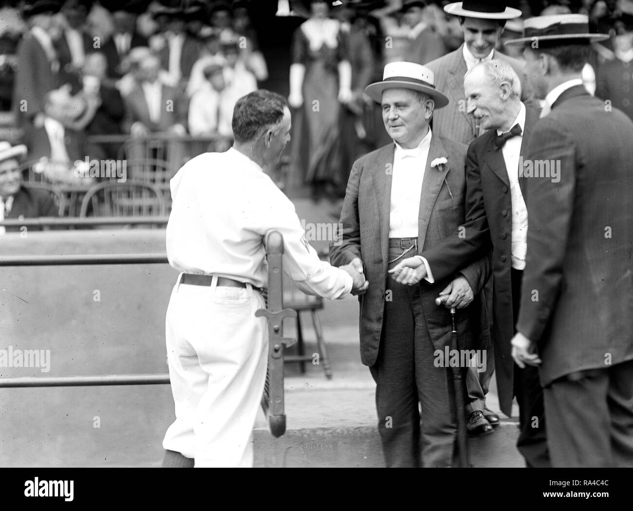 Champ Clark shaking hands with Clark Griffith at a baseball game ca ...