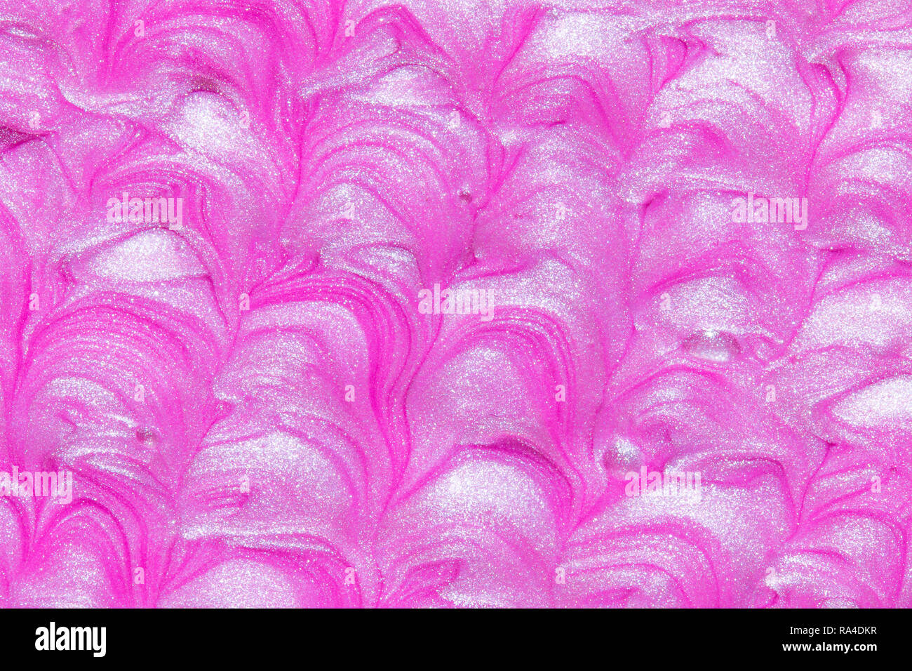 Abstract background of pink and silver metallic liquid paint swirls ...