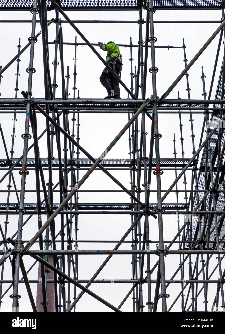 Scaffolders at work, building a large scaffolding, work at high ...
