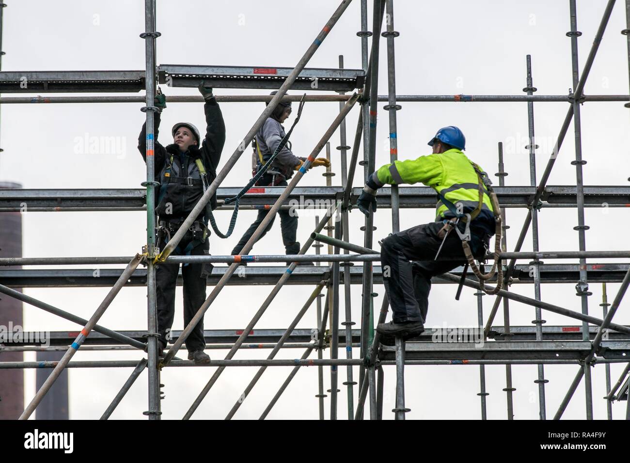 Scaffolders at work, building a large scaffolding, work at high ...
