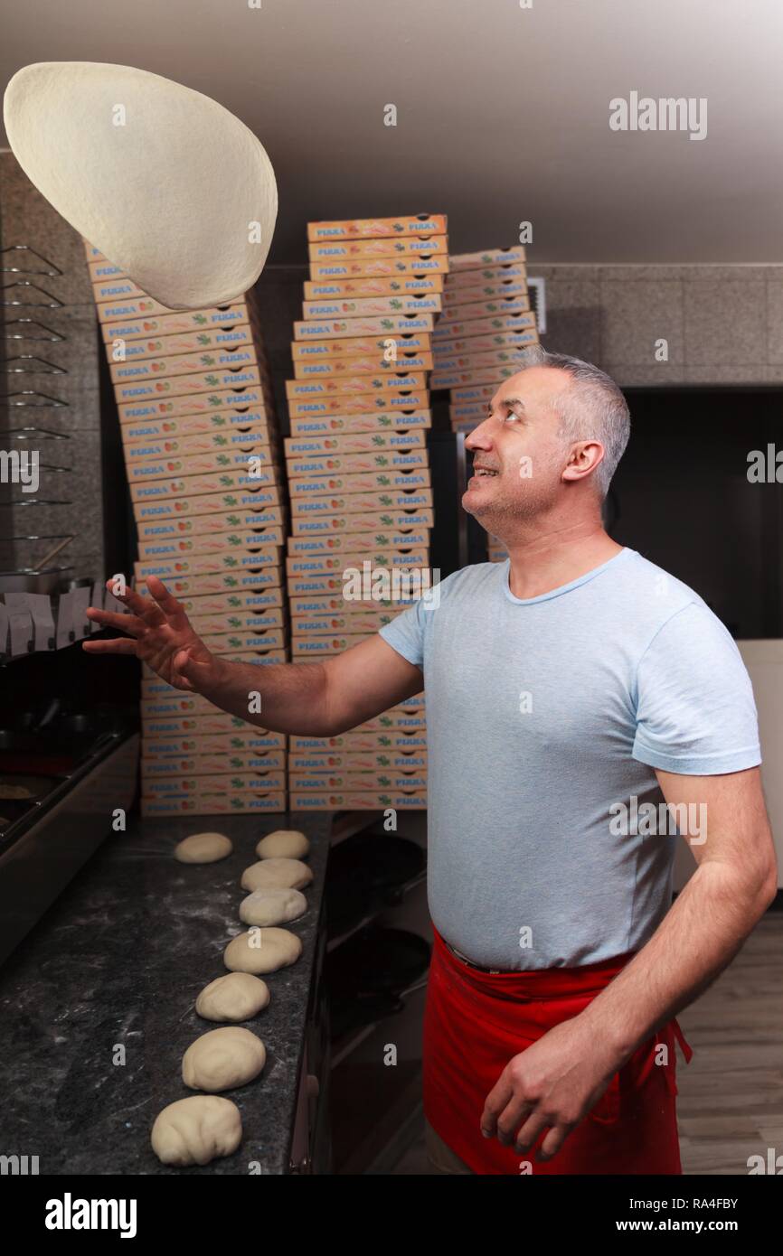 Man, pizza baker, juggles with pizza dough, Germany Stock Photo - Alamy