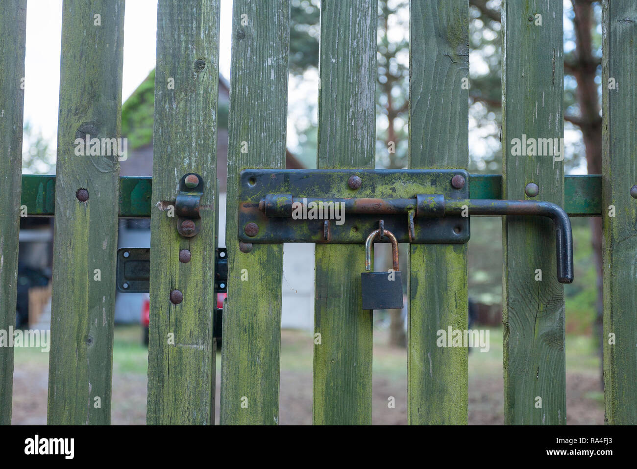 Old vintage rugged lock padlock gate moss rural fence Stock Photo - Alamy