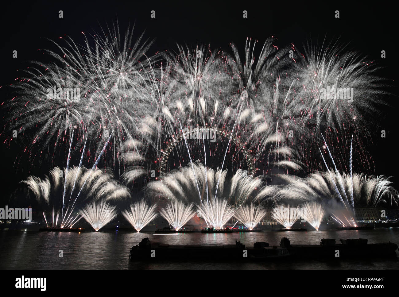 Fireworks light up the sky over the London Eye in central London during ...