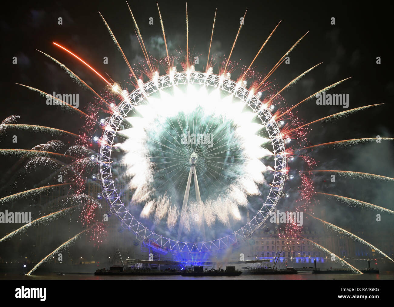 Fireworks light up the sky over the London Eye in central London during ...