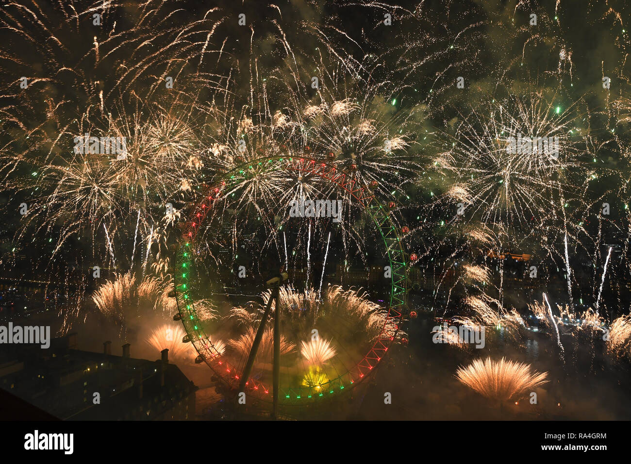 Fireworks light up the sky over the London Eye in central London during ...