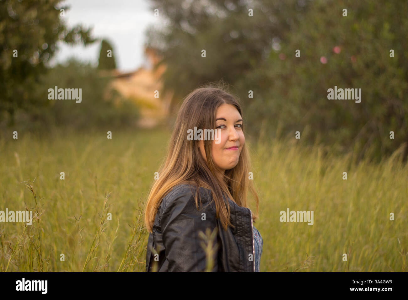 beautiful model with black jacket on outside forest background Stock ...