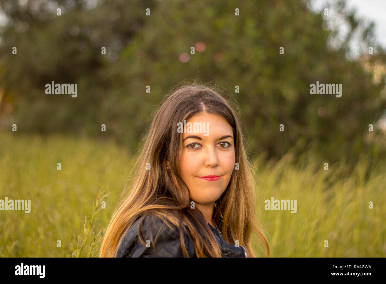 beautiful model with black jacket on outside forest background Stock ...